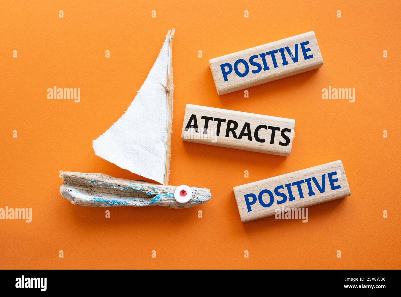 Positive attracts Positive symbol. Wooden blocks with words Positive ...