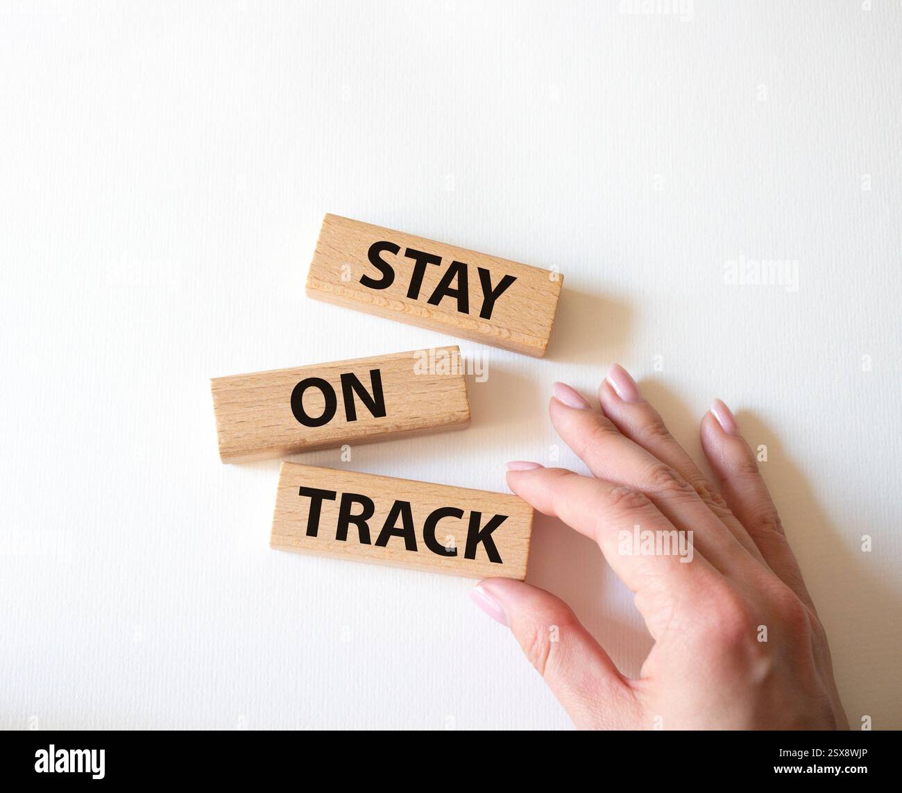 Stay on track symbol. Wooden blocks with words Stay on track. Beautiful ...