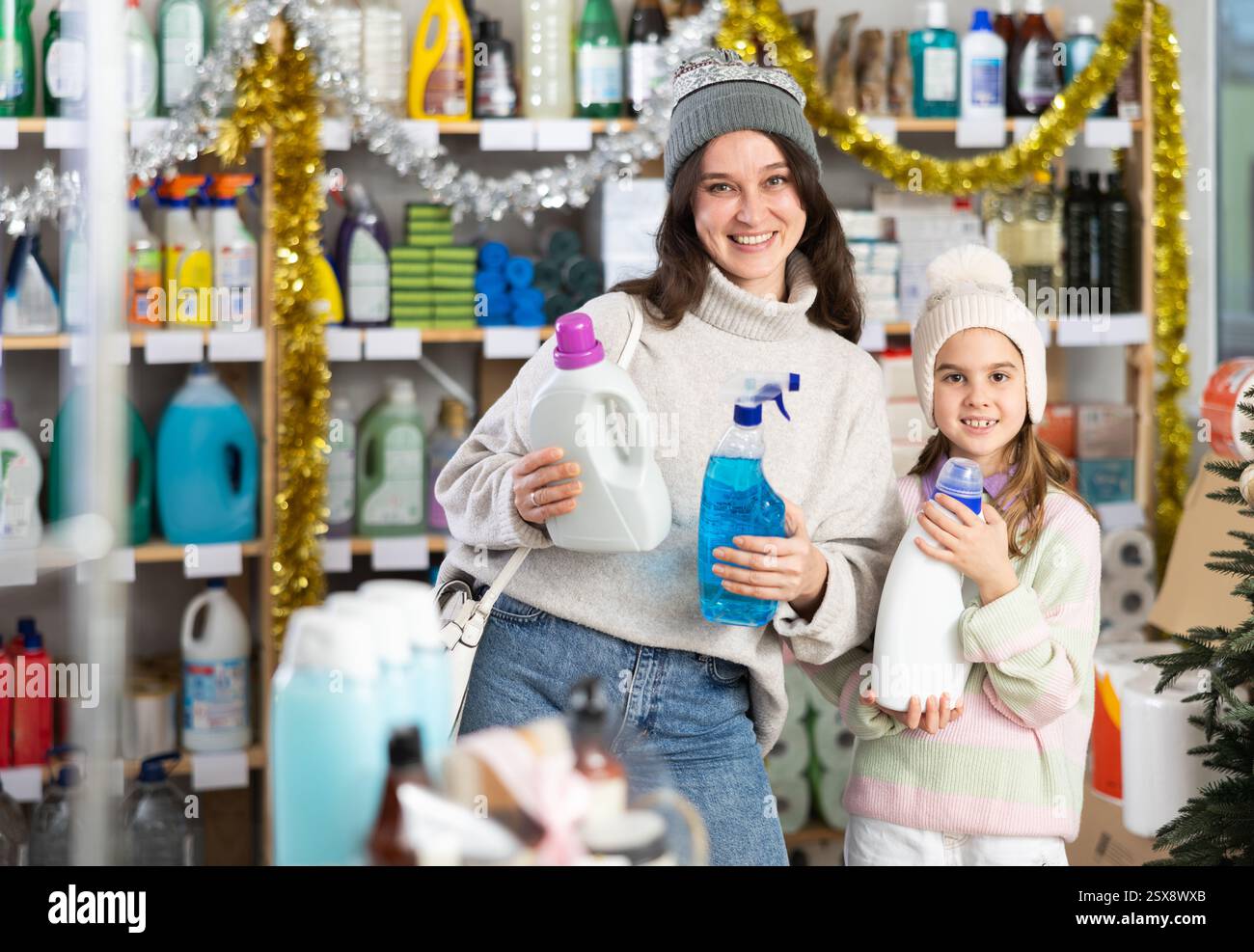 Mother and daughter choose for window cleaning spray and detergent ...