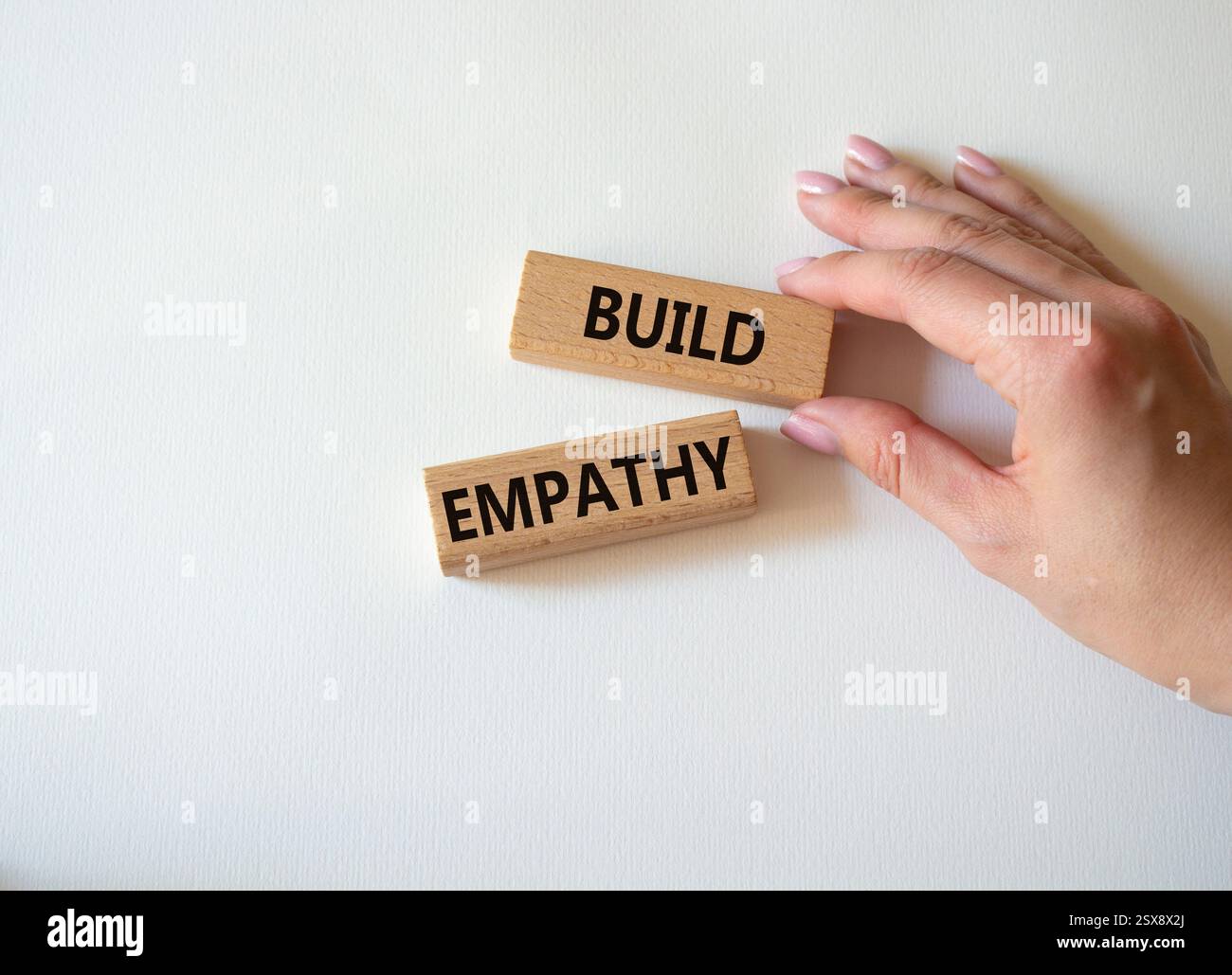 Build empathy symbol. Wooden blocks with words Build empathy ...