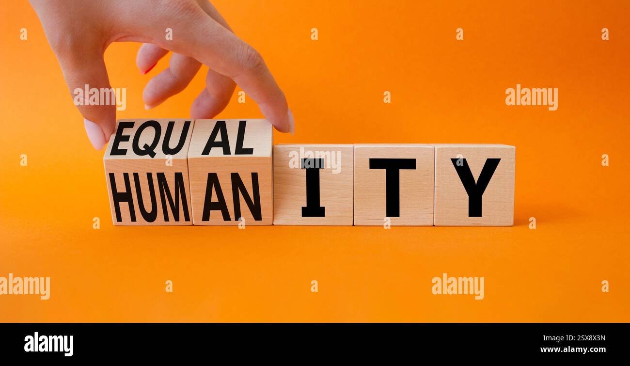 Equality and Humanity symbol. Businessman hand. Turned cubes with words ...