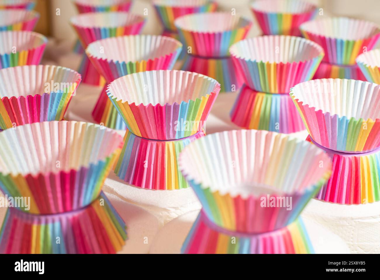 Rainbow muffin cups. Snack cups. Making cupcakes Stock Photo - Alamy