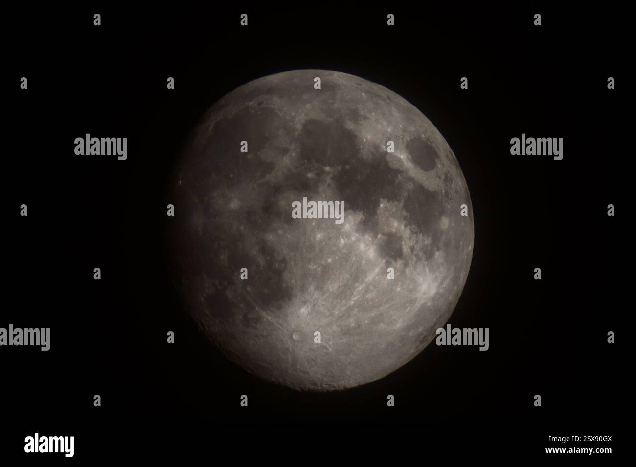 Bright moon in darkness revealing distinct maria and crater patterns ...