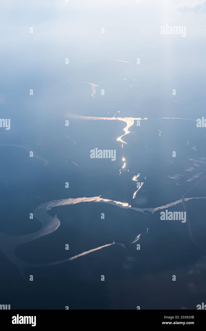 A serene aerial view capturing the winding rivers as they elegantly ...