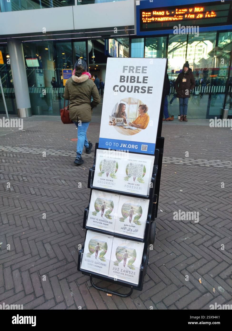 Take-home booklets for a free bible course in front of The Hague train ...