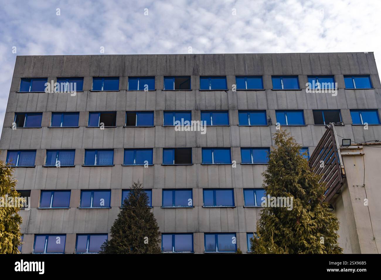Old abandoned office building, broken windows in a block of flats ...