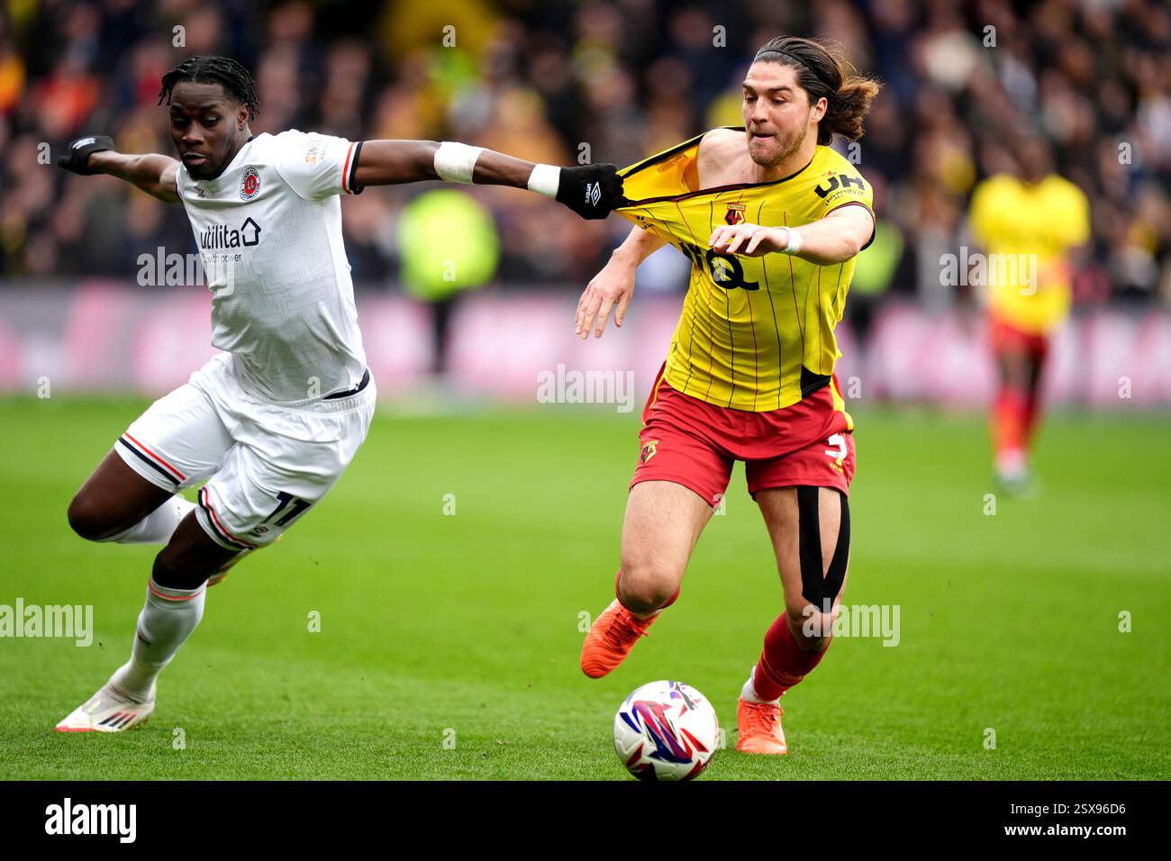 Luton Town's Elijah Adebayo (left) battle for the ball with Watford's ...