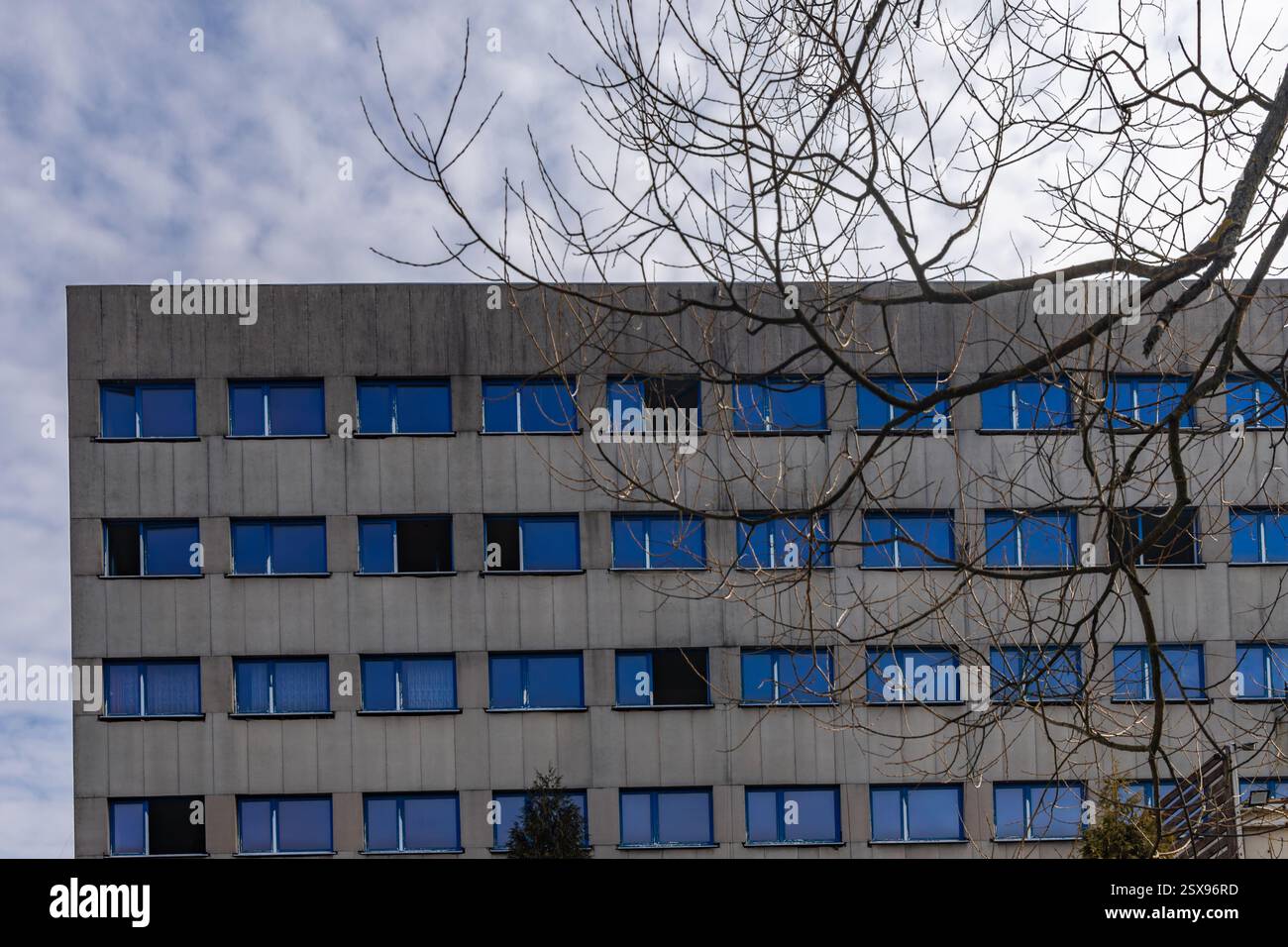 Old abandoned office building, broken windows in a block of flats ...