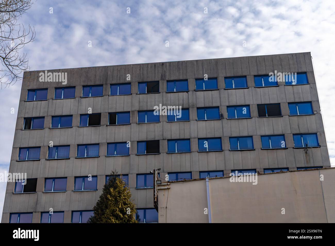 Old abandoned office building, broken windows in a block of flats ...