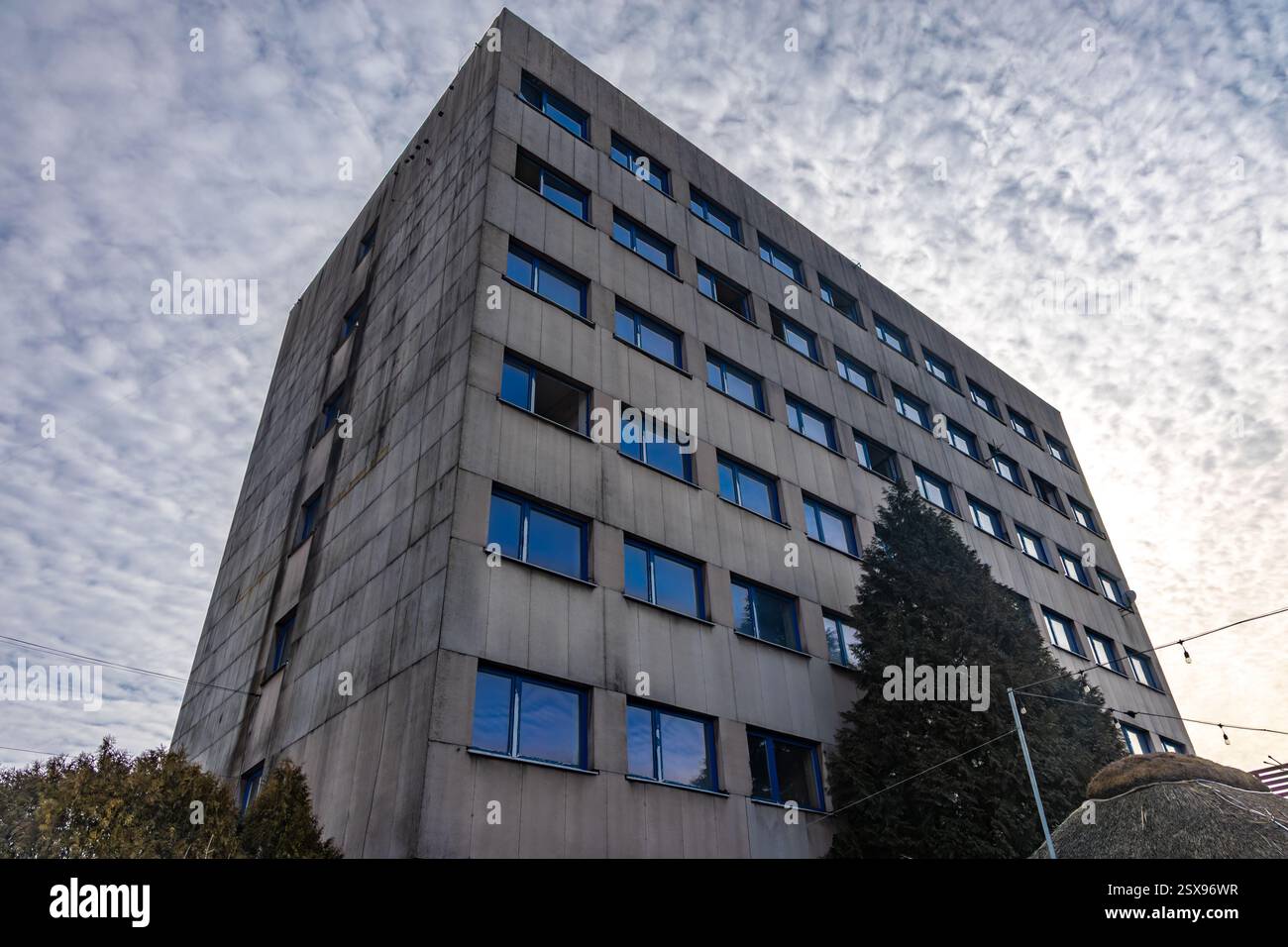 Old abandoned office building, broken windows in a block of flats ...