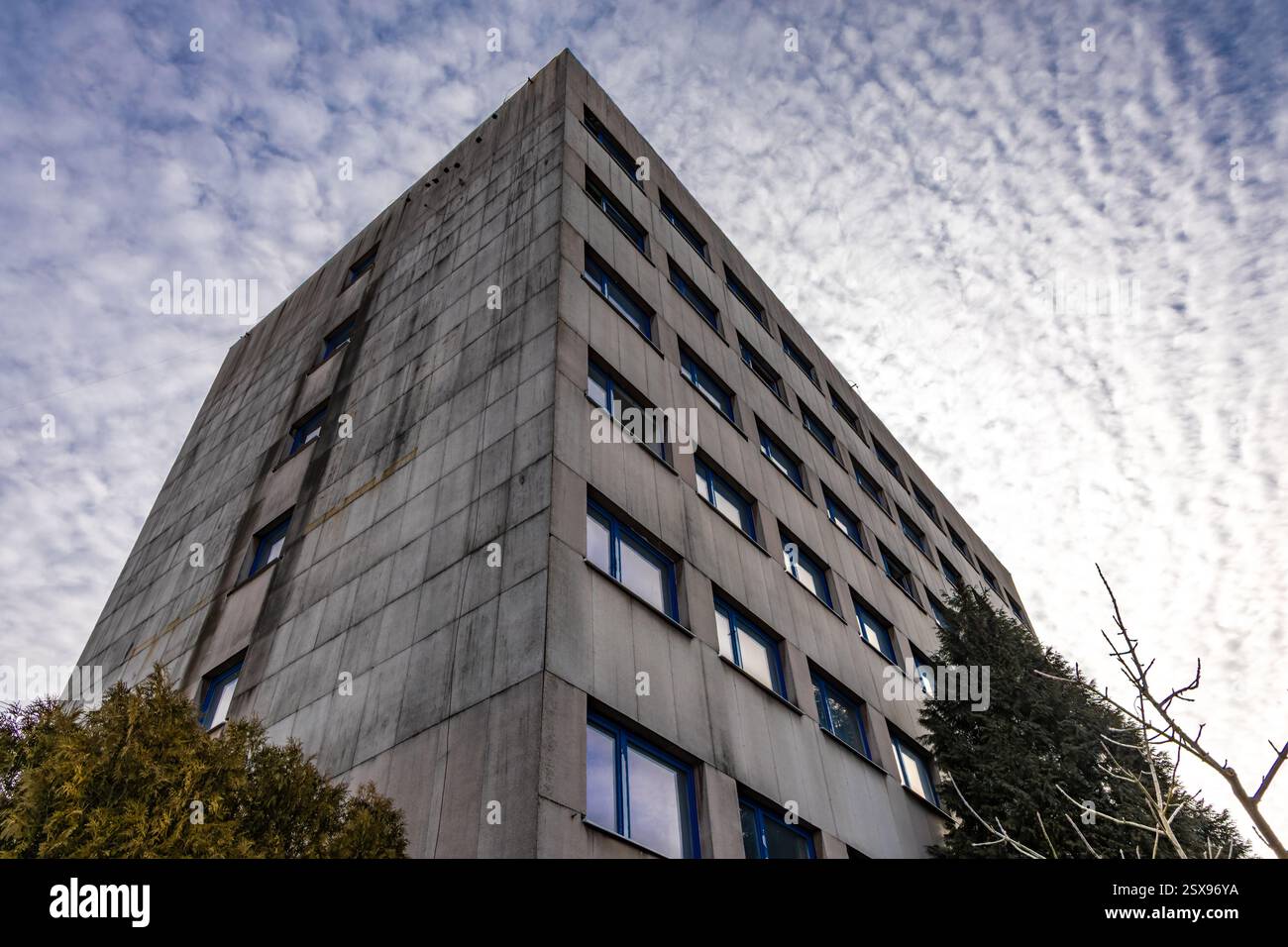 Old abandoned office building, broken windows in a block of flats ...