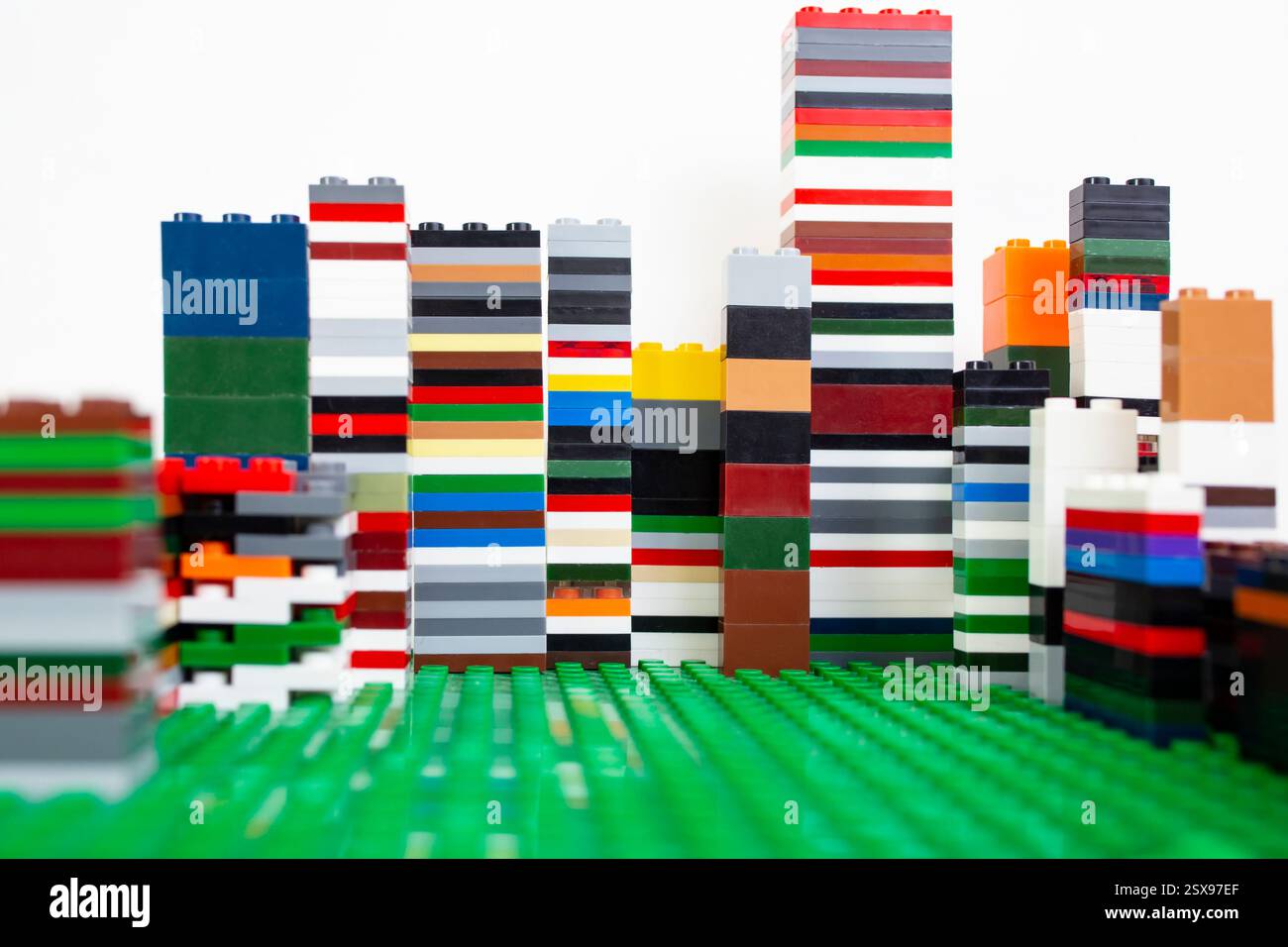 Tall building blocks towers background on green desk , abstract ...