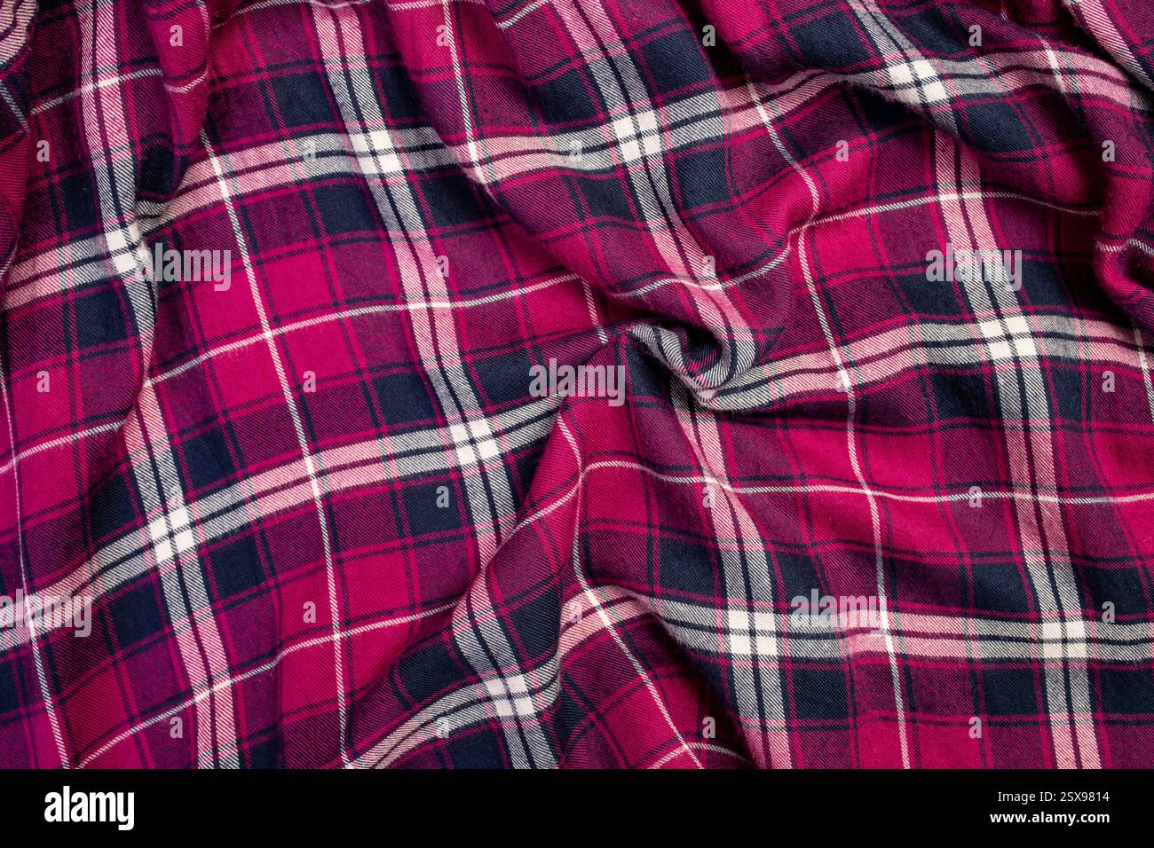 Checkered red fabric swirl crease with podium in focus for product ...
