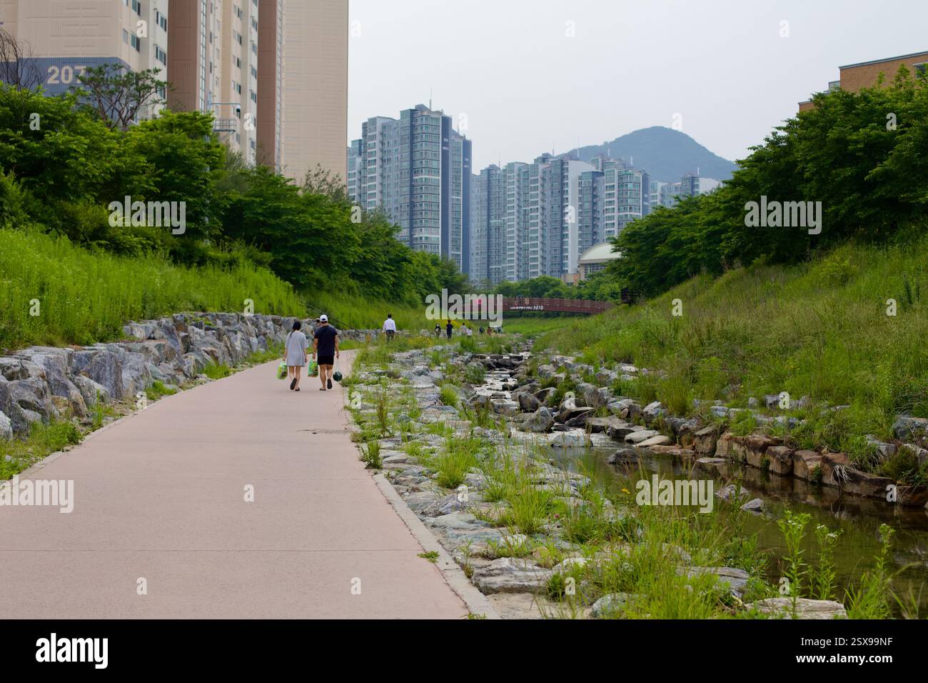 Daejeon, South Korea - May 28th, 2021: People walk along a paved path ...