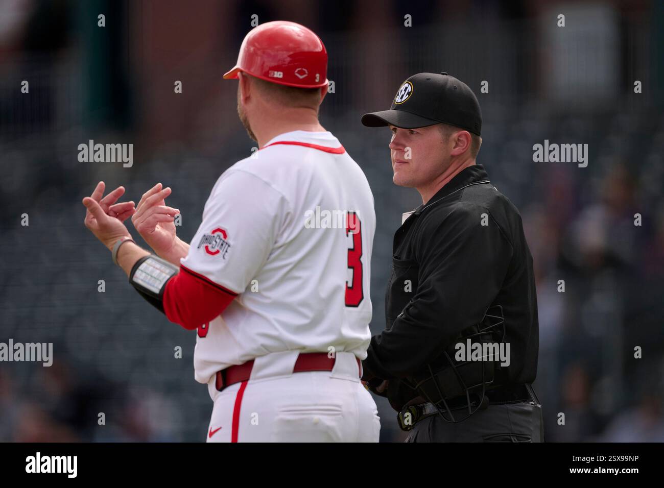 Ohio State Buckeyes head coach Justin Haire (3) discusses a call with ...