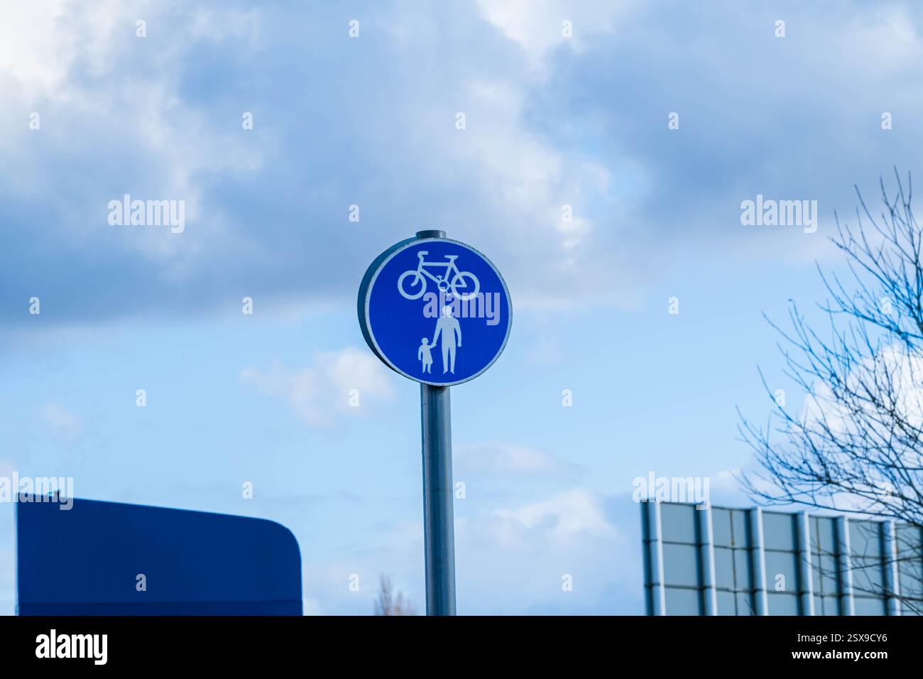 UK pedestrian signpost advising people walking and cycling sharing the ...