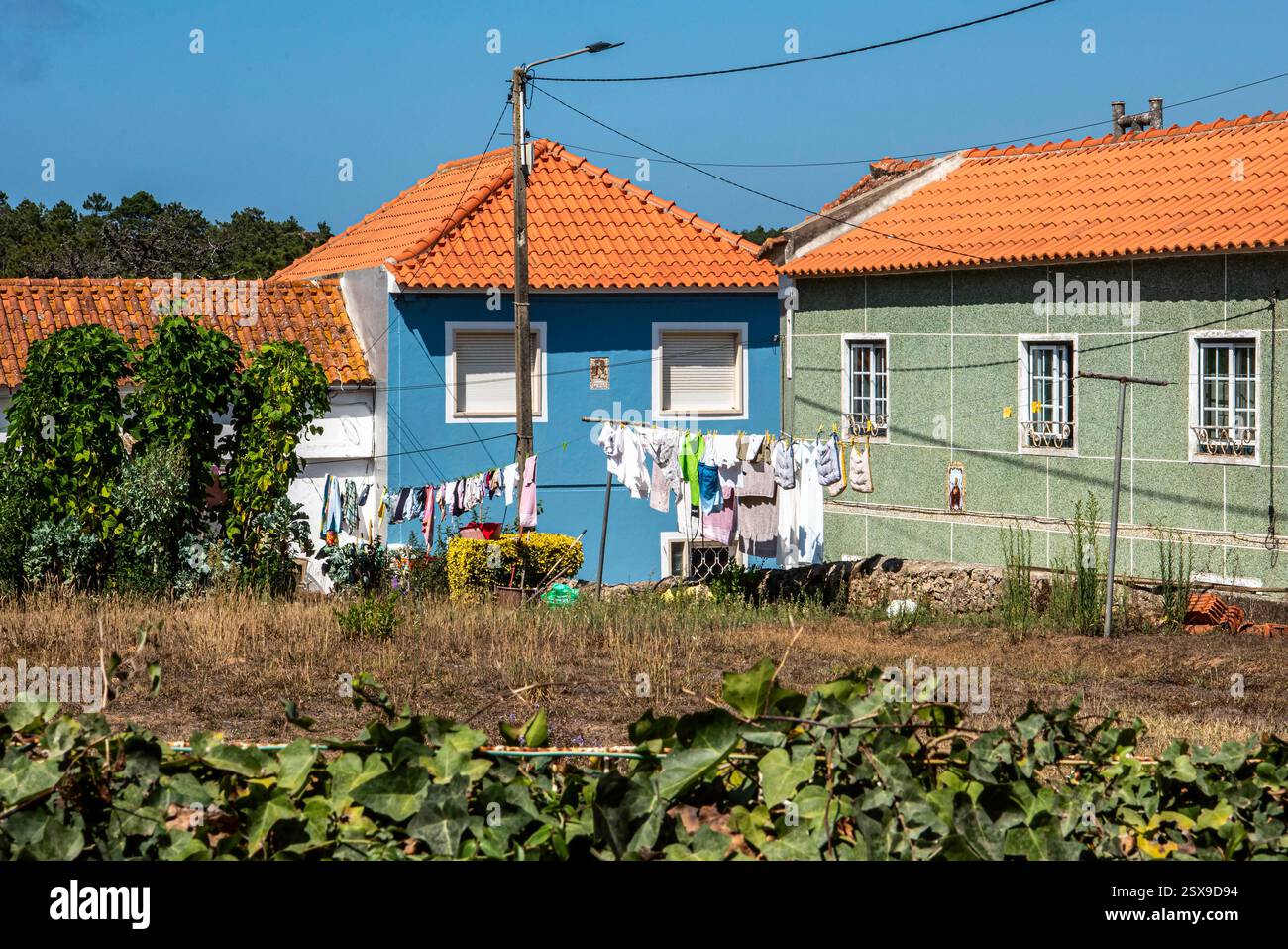 Colorful rural Portuguese homes with orange tiled roofs and laundry ...
