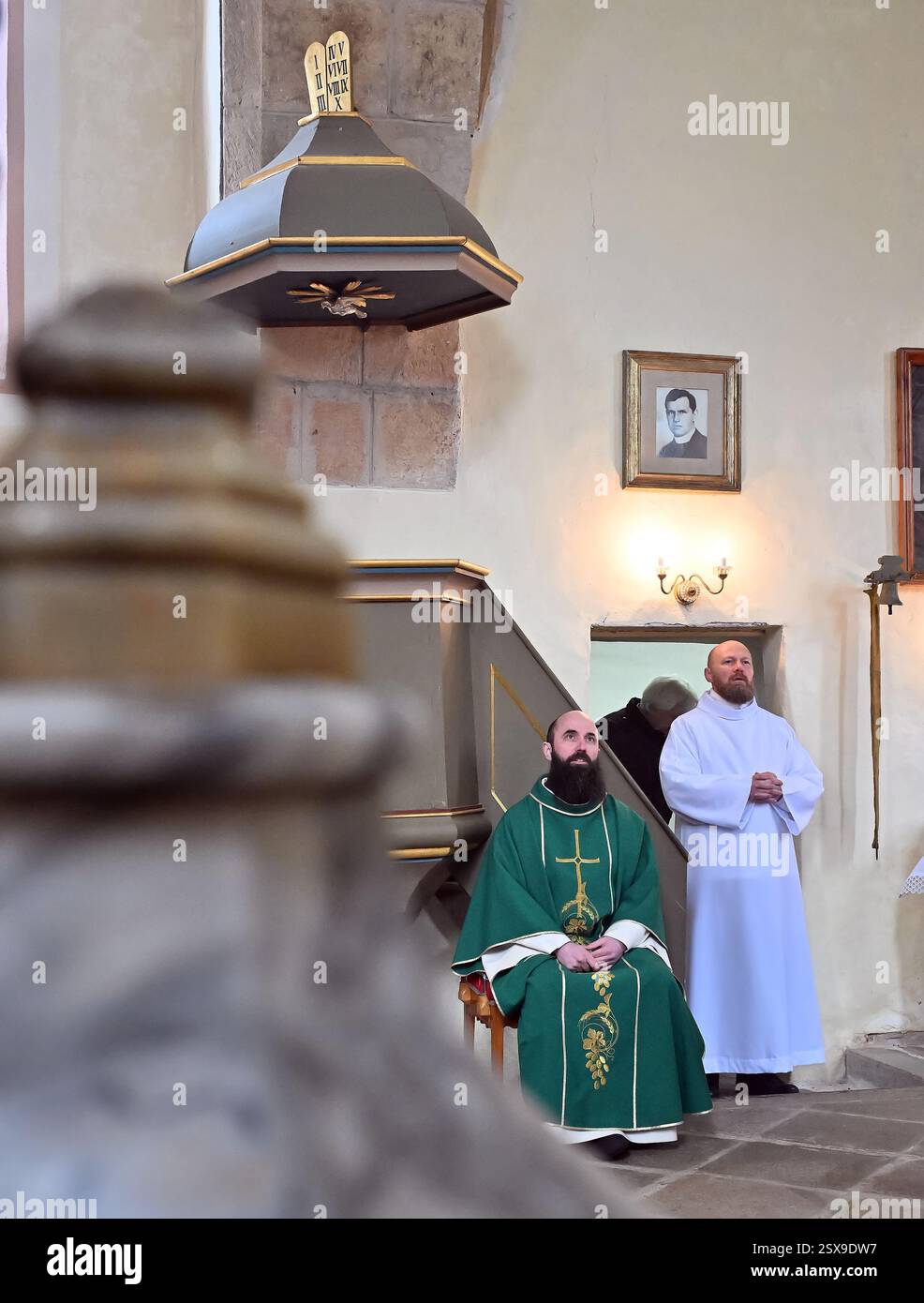 Priest Pavel Pola of the Barefoot Carmelite Order, left, attends a mass ...