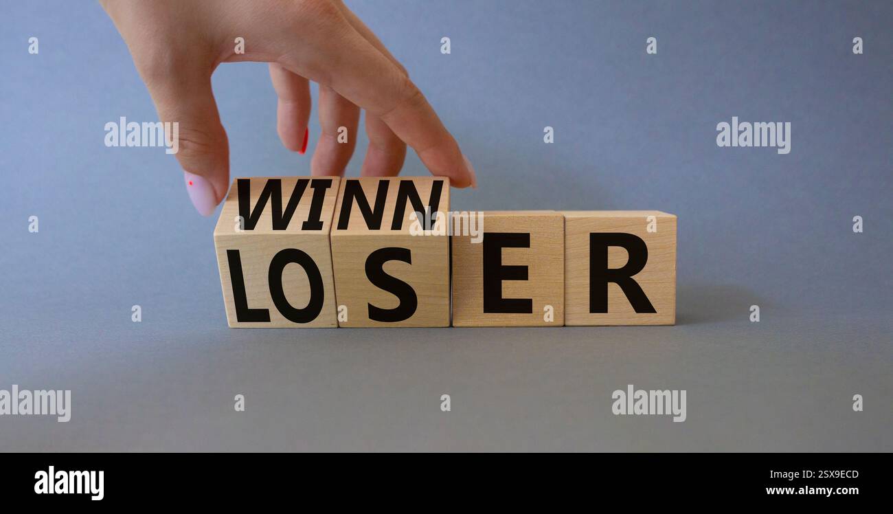 Winner and Loser symbol. Businessman hand turnes wooden cubes and ...