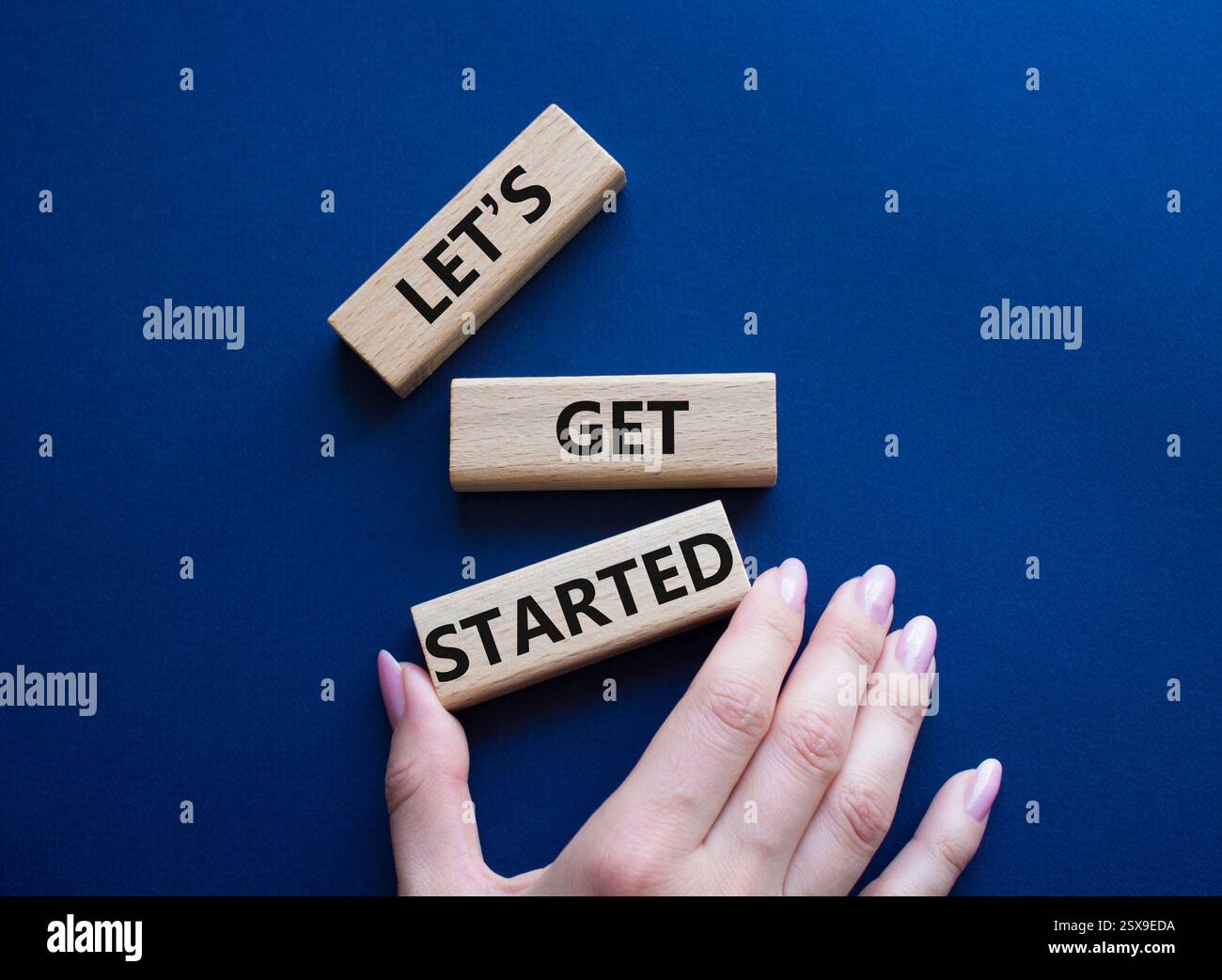 Lets get started symbol. Concept words Lets get started on wooden ...