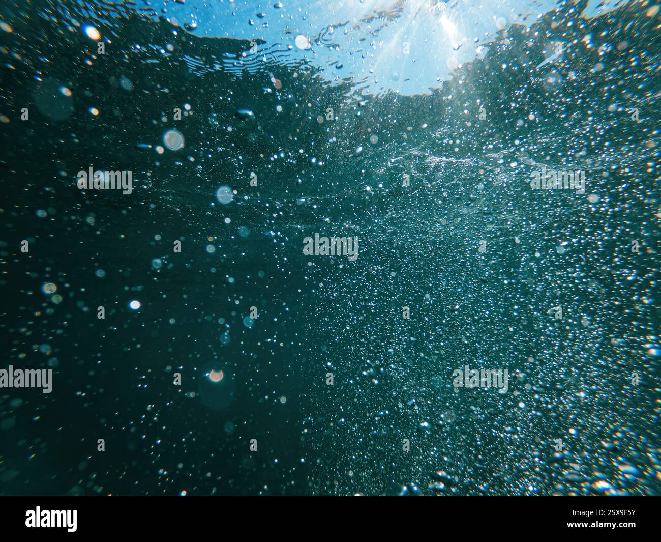 Underwater air bubbles in clean blue ocean water as natural background ...