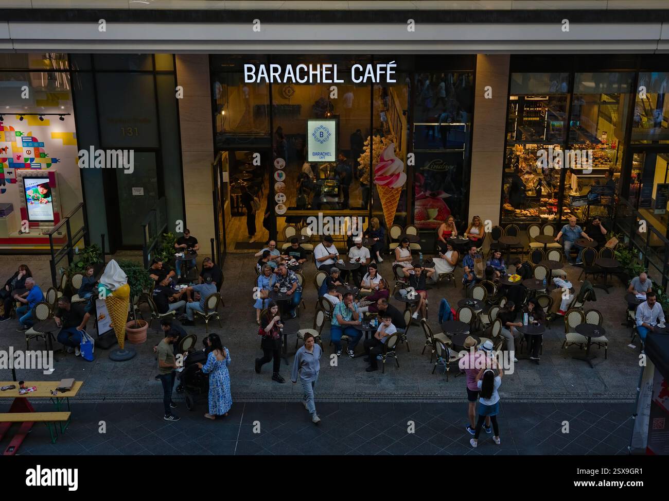 A local ice cream cafe at the mall of Berlin, where people are enjoying ...