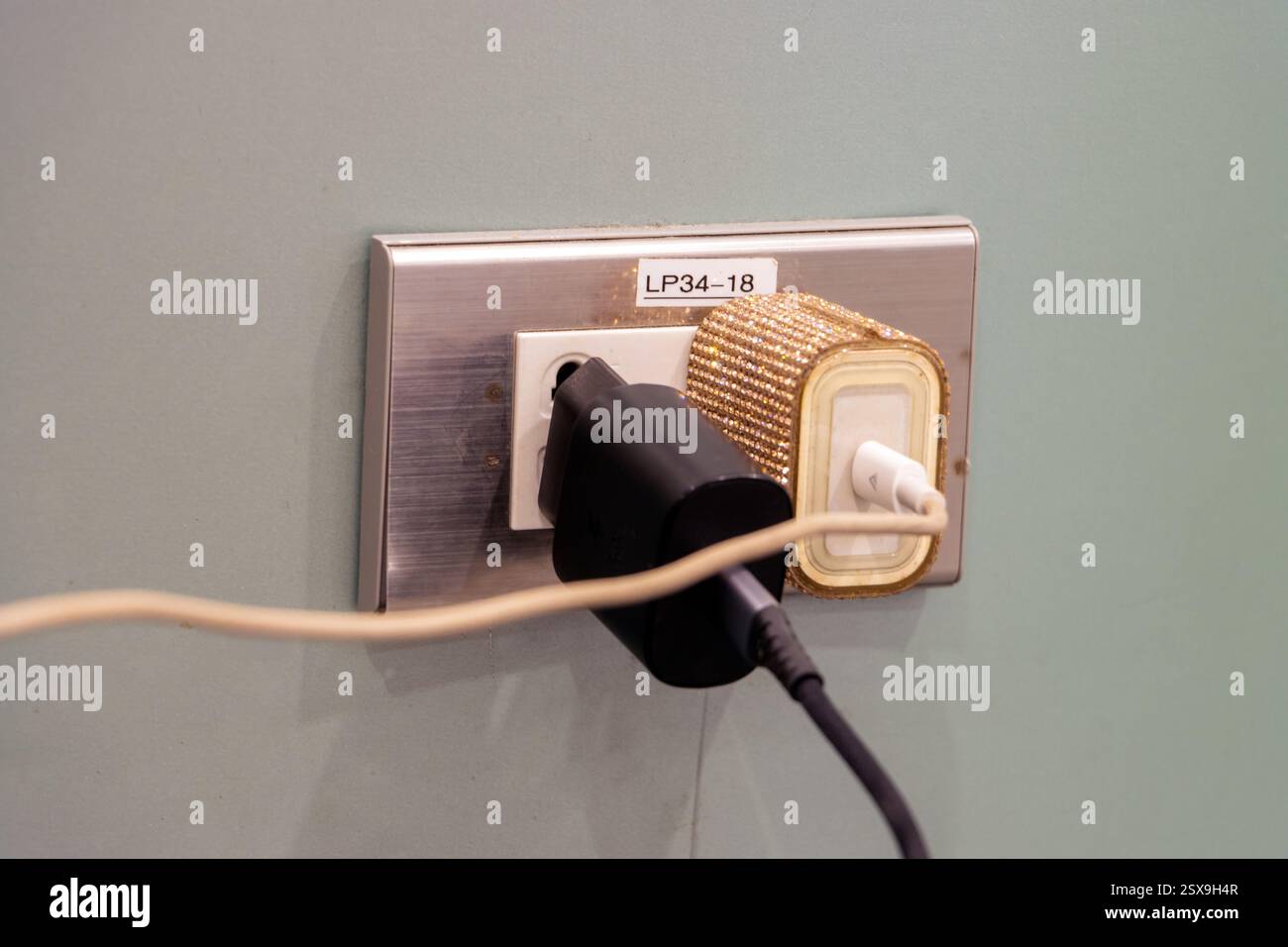 Electrical outlet with mobile device adapters connected Stock Photo - Alamy