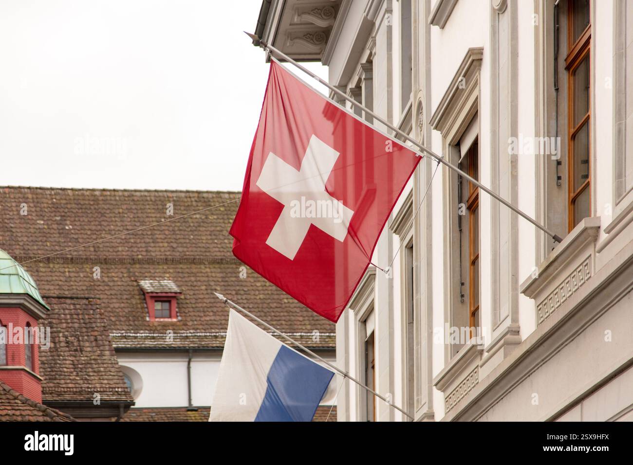 Swiss flag hanging from a pole on a building facade, Traditional ...