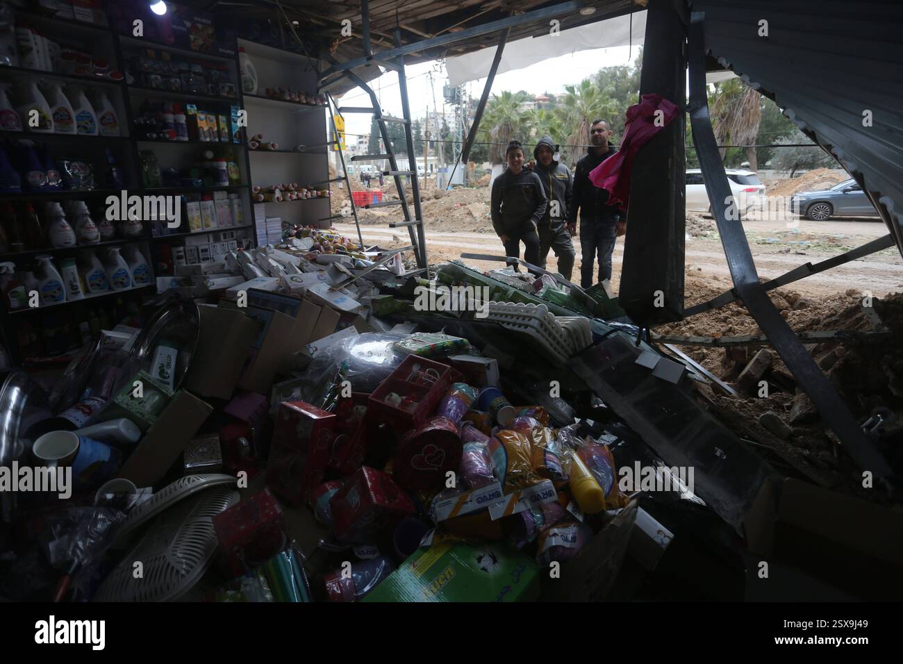 Palestinians inspect the destruction after Israeli attacks on the town ...