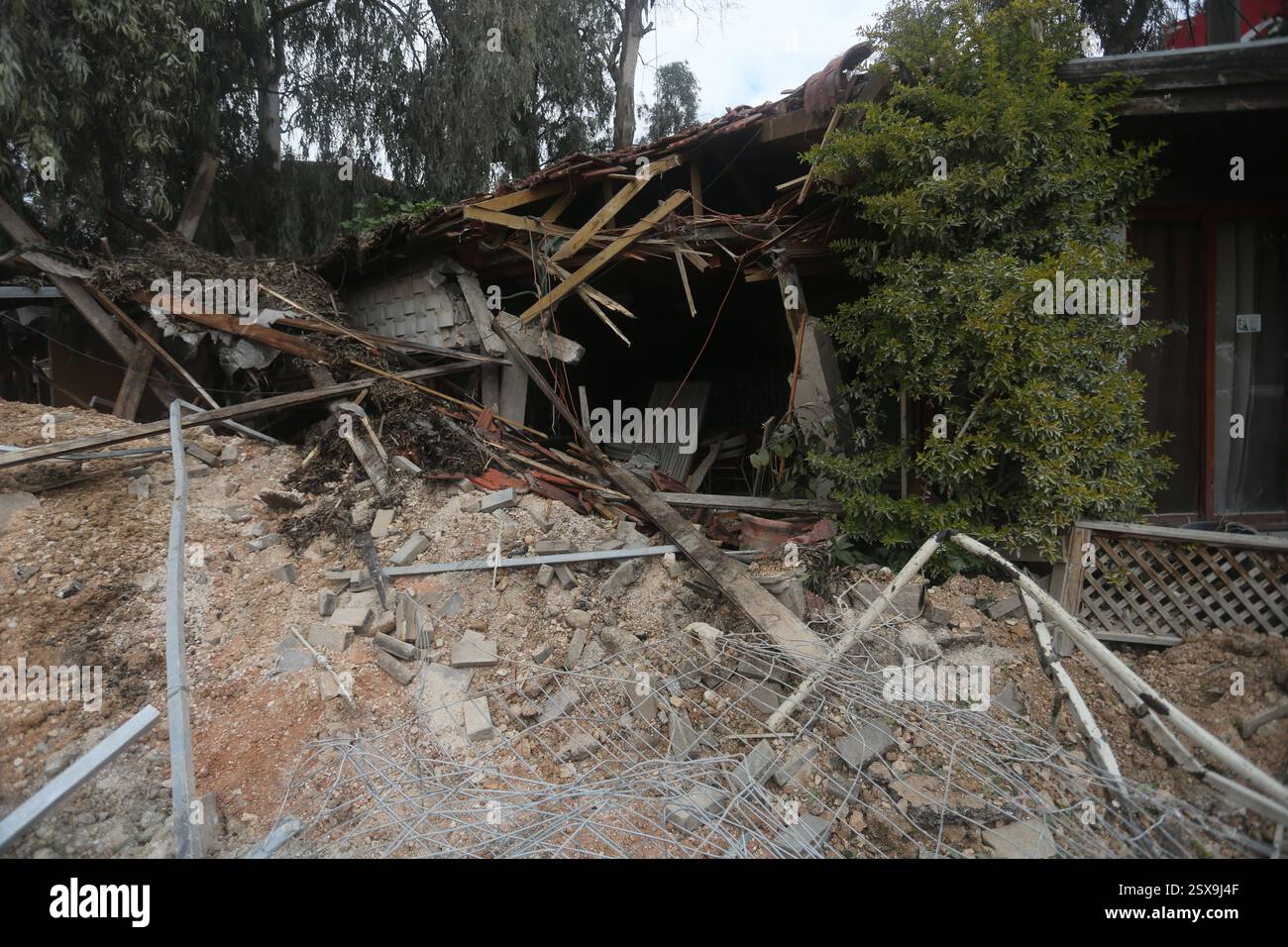 Palestinians inspect the destruction after Israeli attacks on the town ...