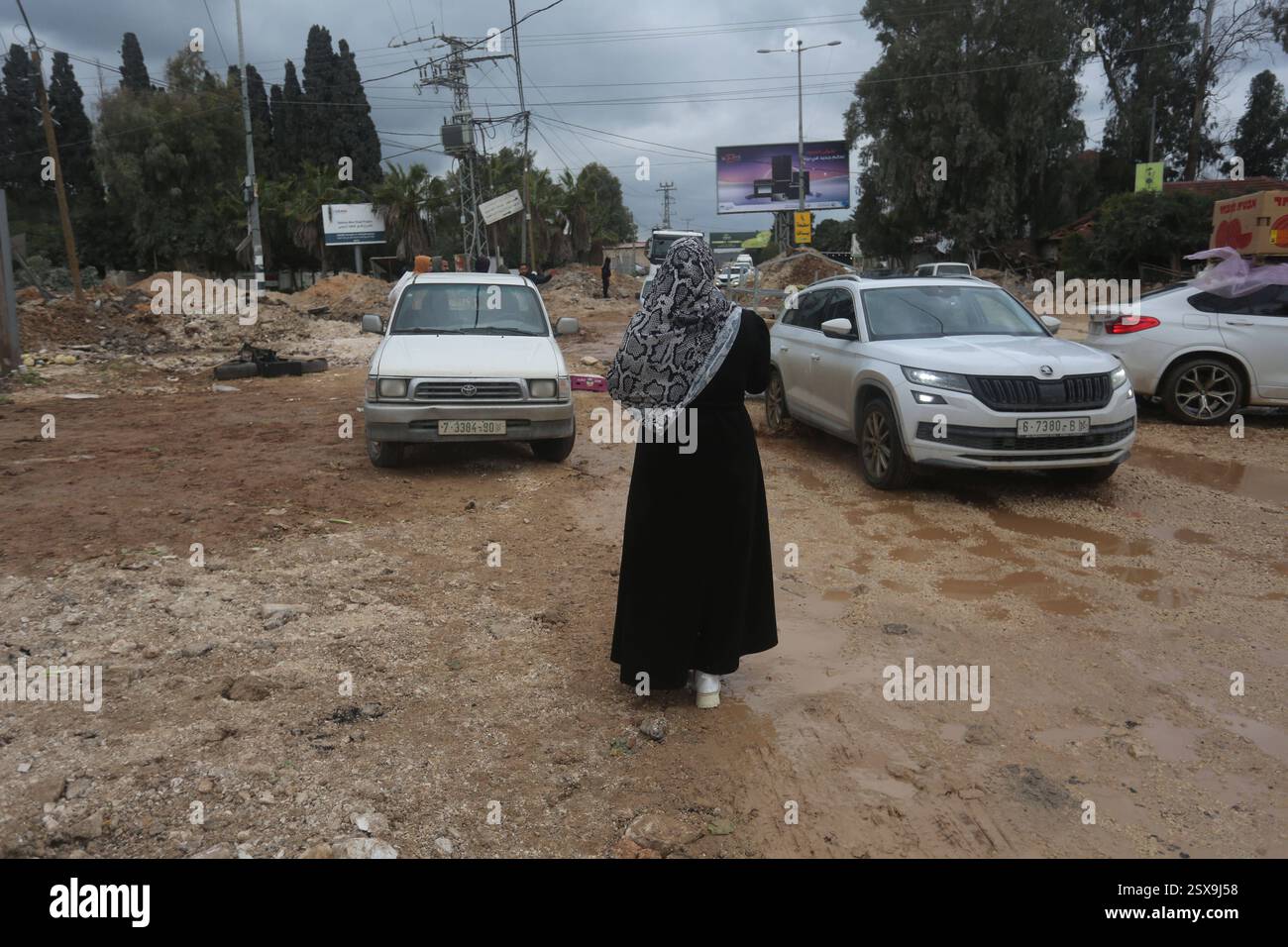 Palestinians inspect the destruction after Israeli attacks on the town ...