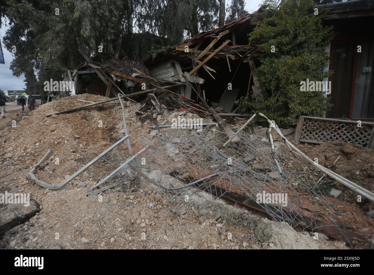 Palestinians inspect the destruction after Israeli attacks on the town ...