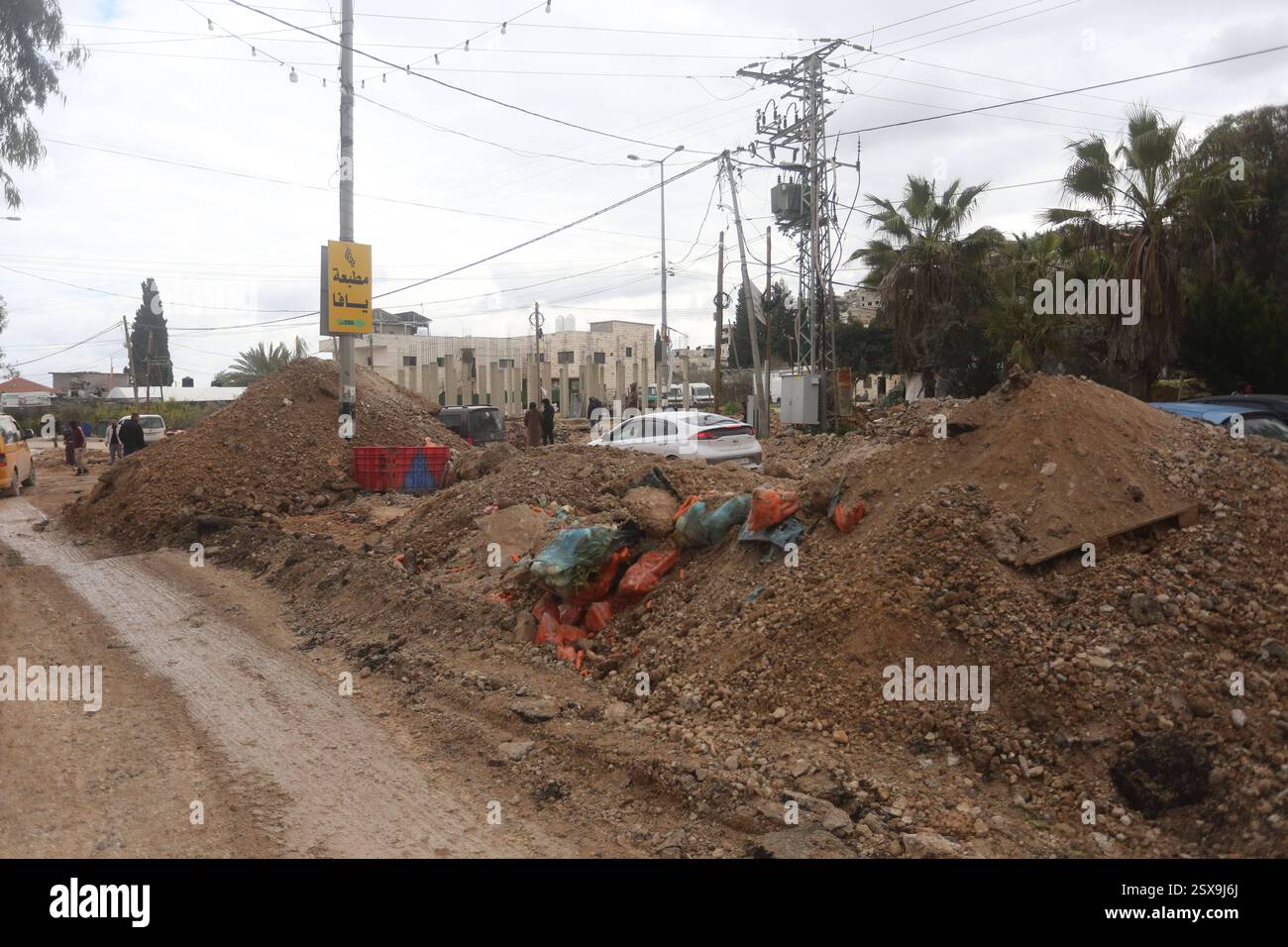 Palestinians inspect the destruction after Israeli attacks on the town ...