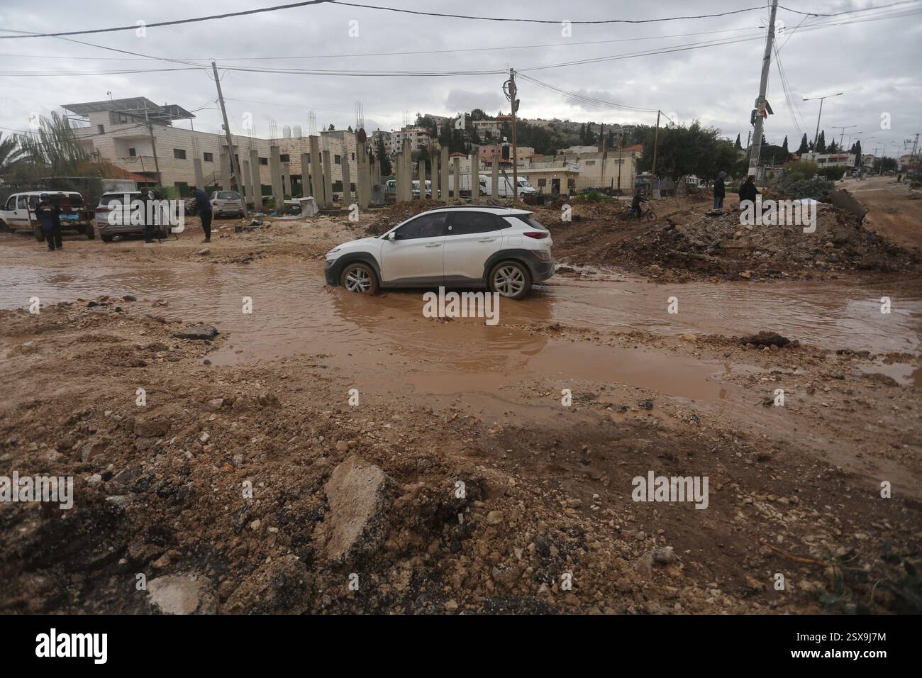 Palestinians inspect the destruction after Israeli attacks on the town ...