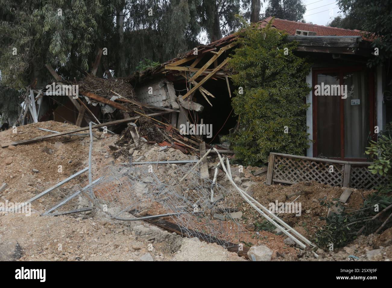 Palestinians inspect the destruction after Israeli attacks on the town ...