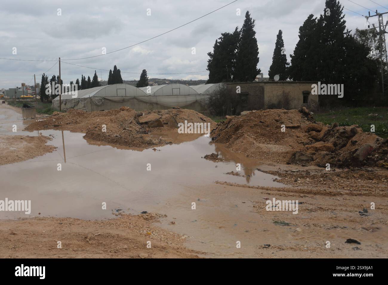 Palestinians inspect the destruction after Israeli attacks on the town ...