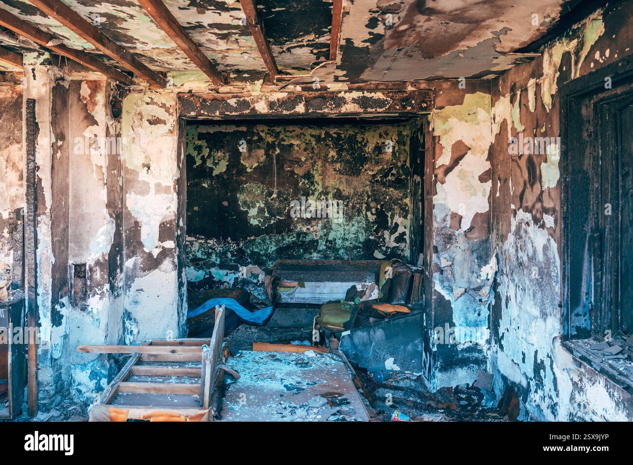 Burned down house, detail of the room after arson, selective focus ...