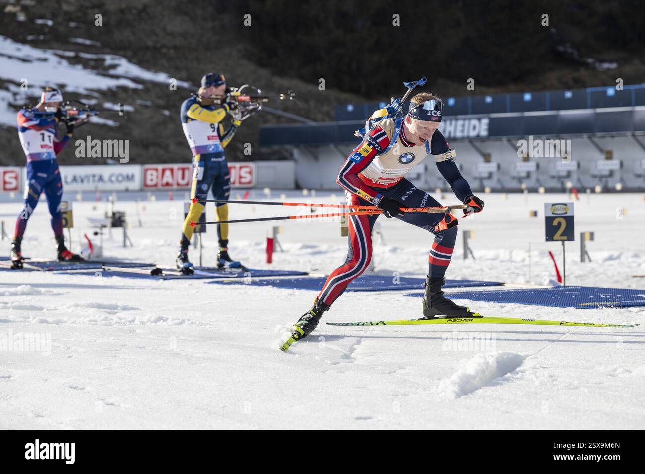 Johannes Thingnes Boe of Norway, right, leaves the shooting range ahead ...