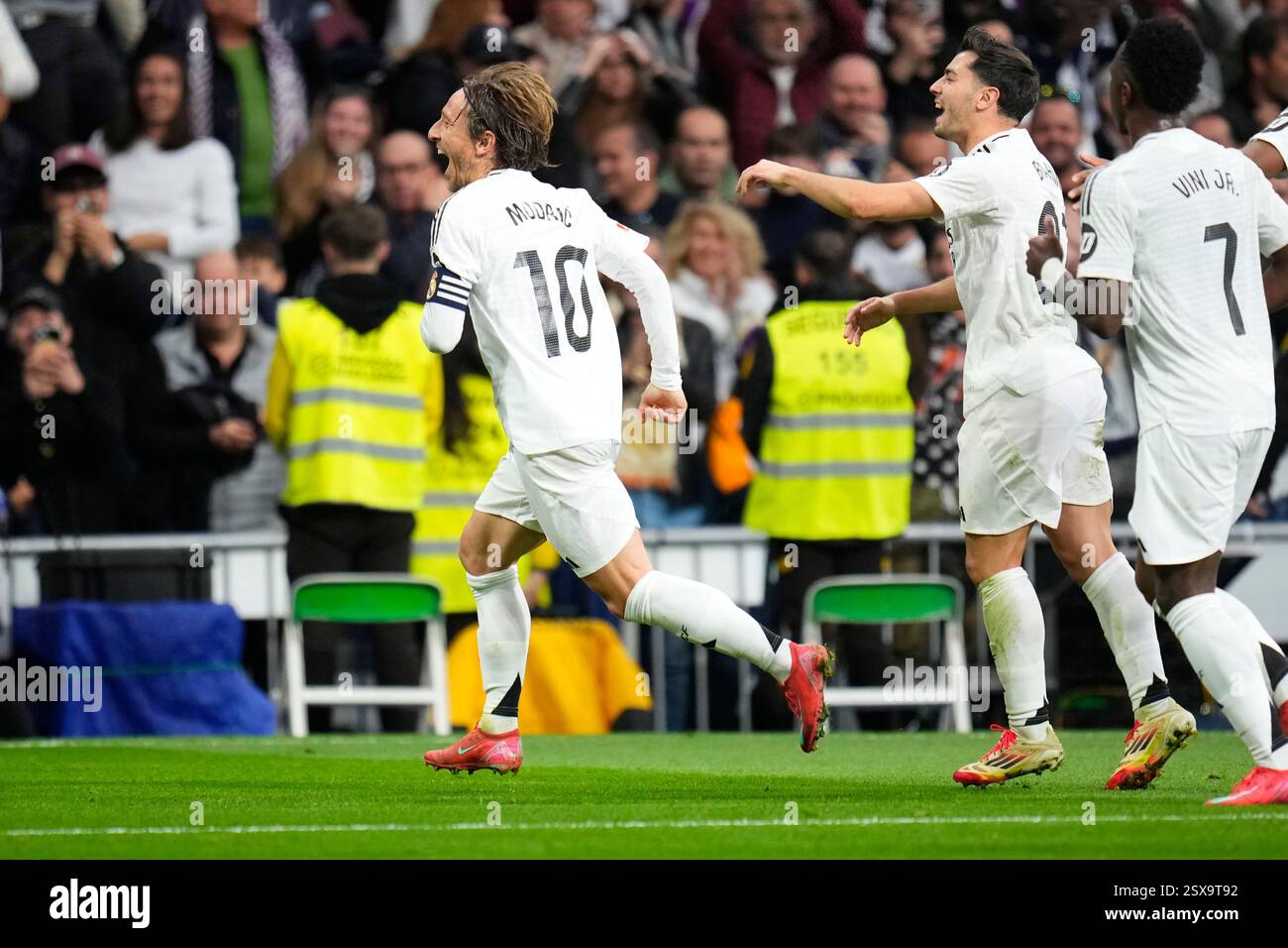 Real Madrid's Luka Modric, left, celebrates after scoring the opening ...