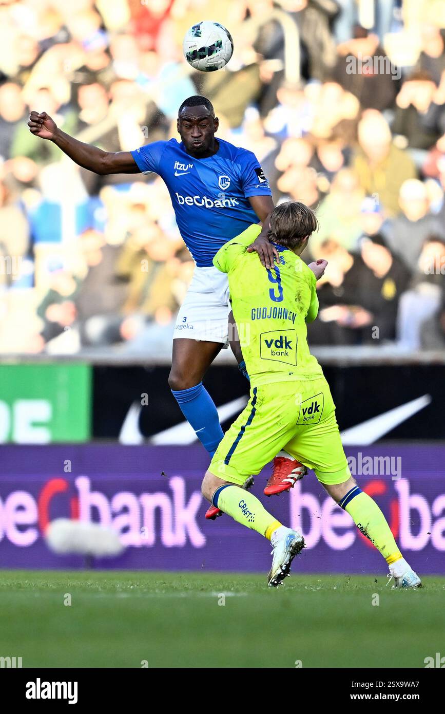 Genk's Mujaid Sadick and Gent's Andri Gudjohnsen fight for the ball ...