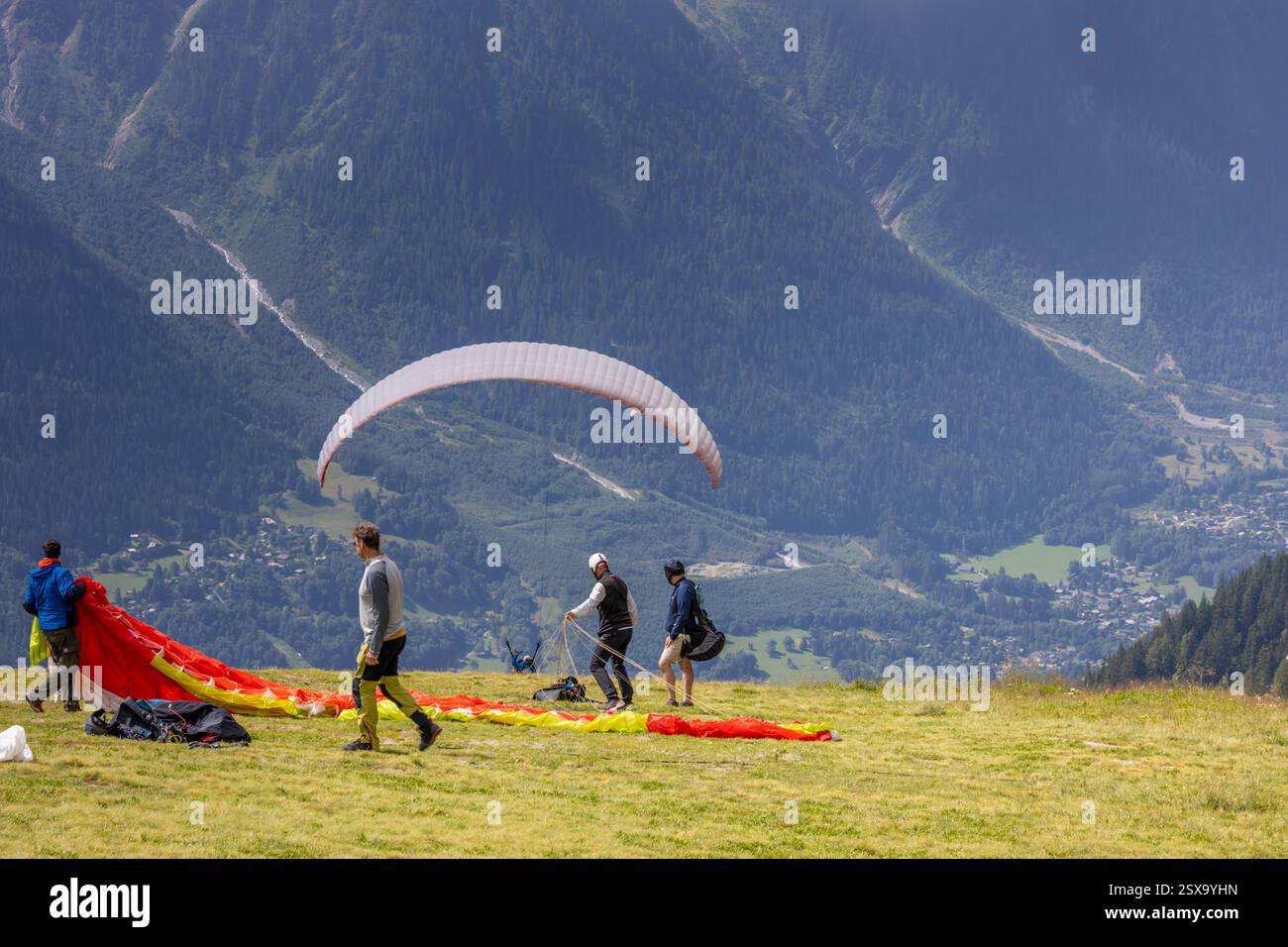 Paraglider flying in the mountains in Chamonix valley. Starting point of paragliders on Brevent ...