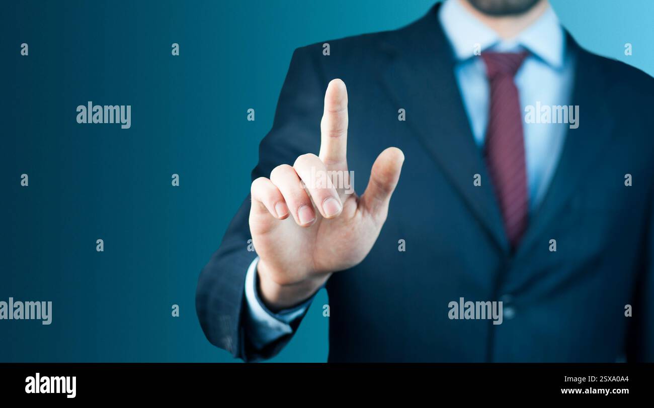 Business man in blue suit pointing his finger Stock Photo - Alamy
