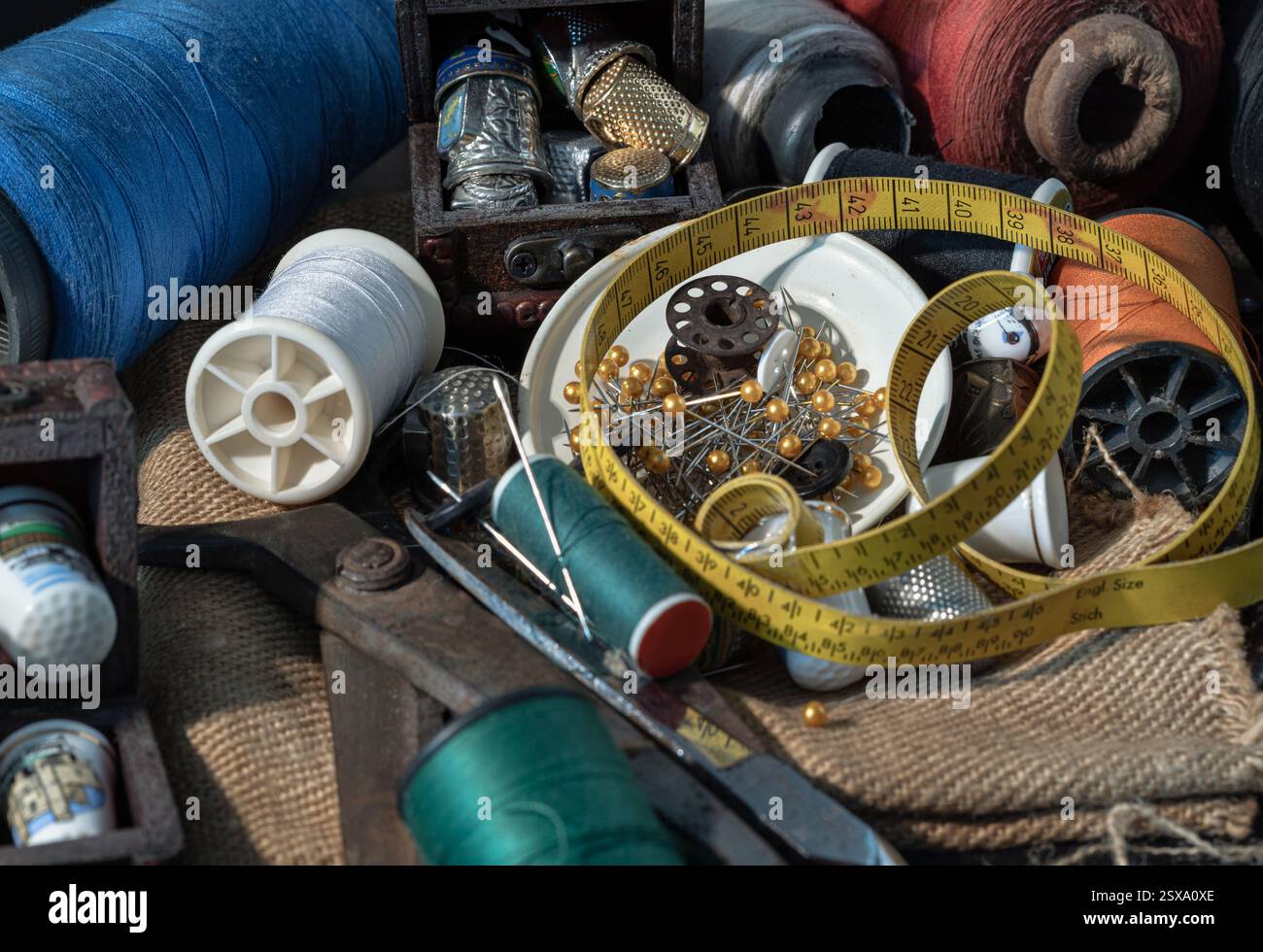 Spools of thread of various colors, Thimbles in small wooden treasure ...