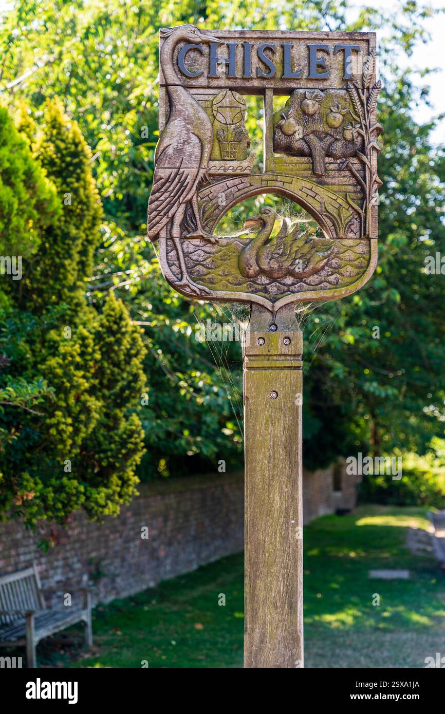 The wooden sign for the village of Chislet in Kent, featuring a stork ...