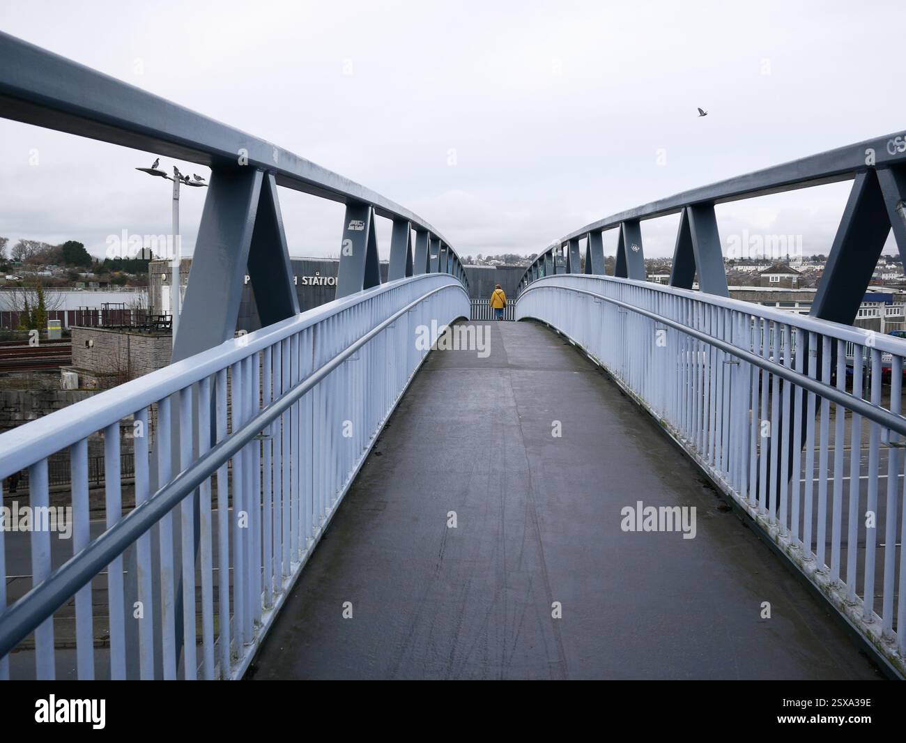 A pedestrian overpass allows pedestrians to cross a road safely using ...