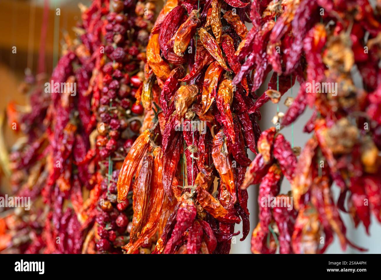 Closeup of dried Chilli peppers hanging on a market stall Stock Photo ...