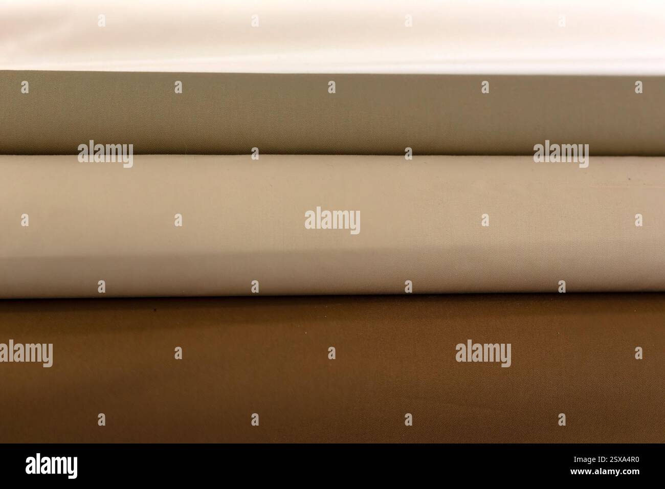 Bolts of fabric cloth on a market stall for use as a background texture ...