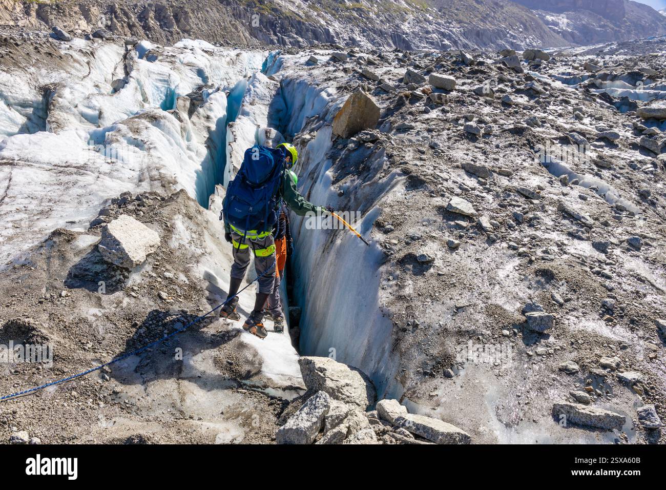 Alpine climbers rope team on a glacier in Chamonix valley training the ...