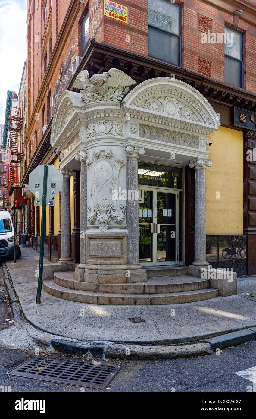 An elaborate cast iron storefront inset with stone and terra cotta at ...