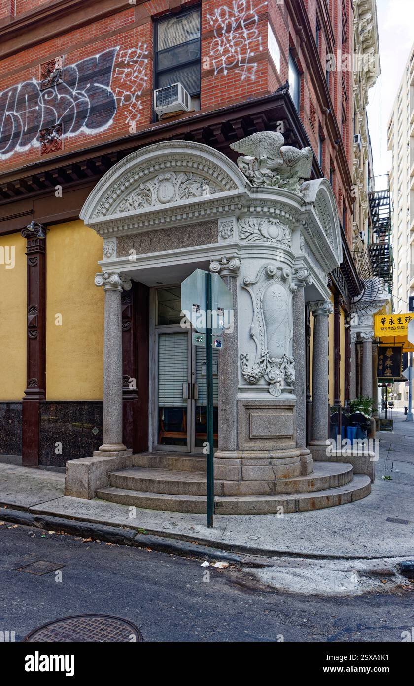 An elaborate cast iron storefront inset with stone and terra cotta at ...